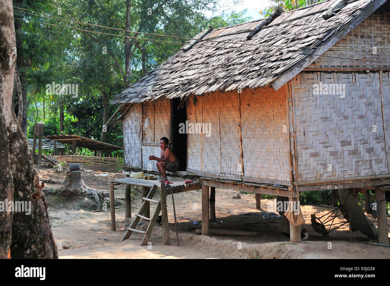 Traditional Hmong village house on stilts on the banks of The Mekong ...