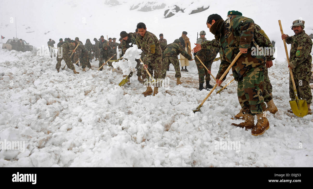 Afghan National Army soldiers use shovels to dig snow off the road in ...