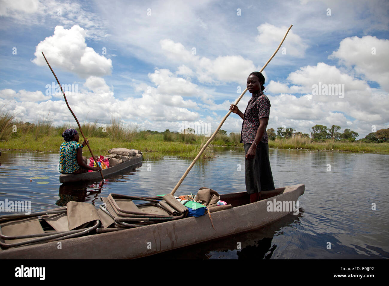 Female poler on her traditional boat in the okavango delta hi-res stock ...