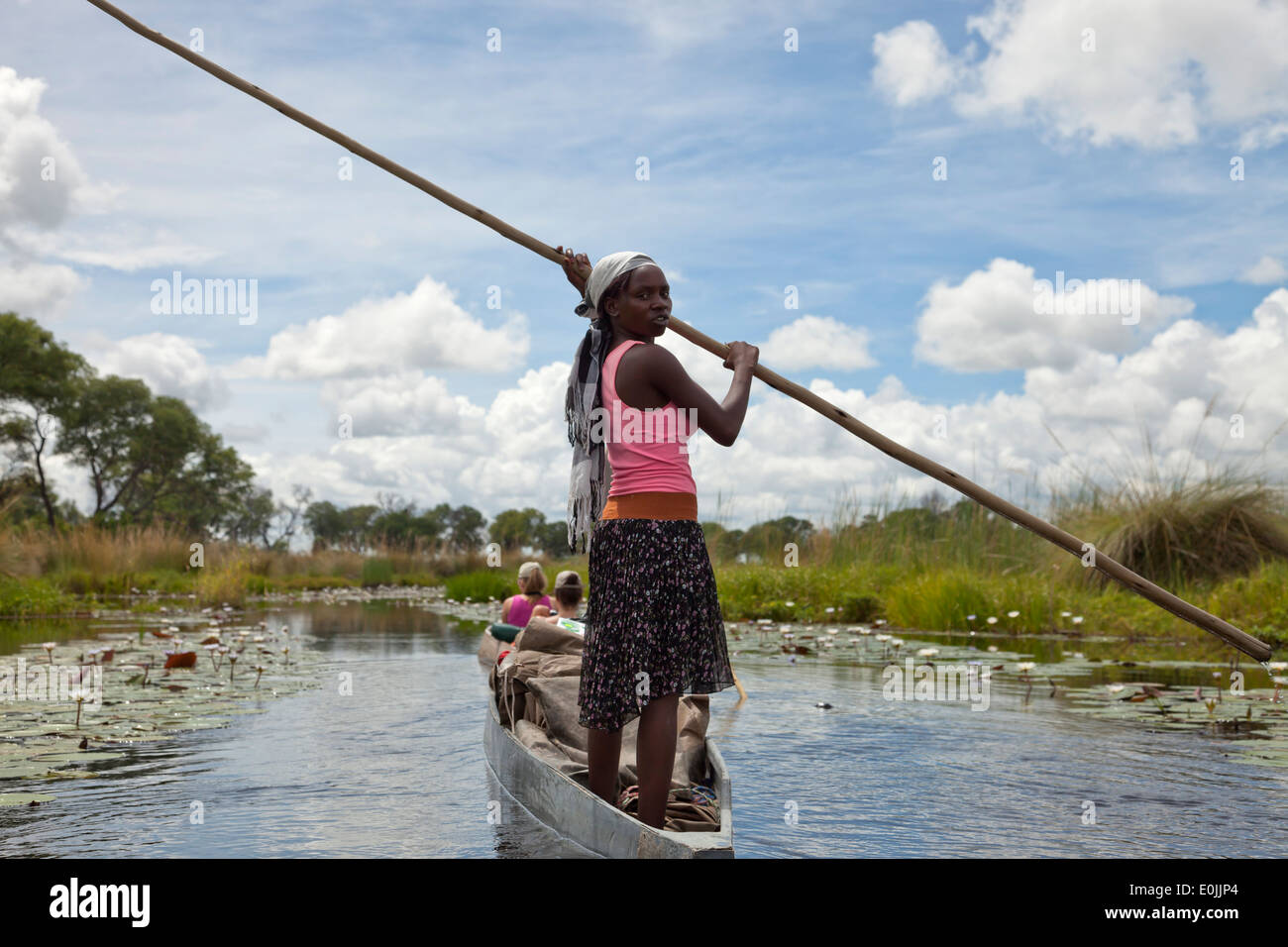 Poler on their traditional mokoro boat in the okavango delta hi-res ...