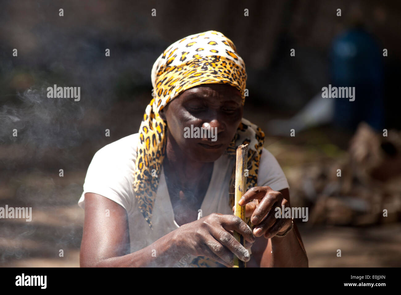 Kavango woman preparing the traditional maize flour dish Ugali or Pap ...