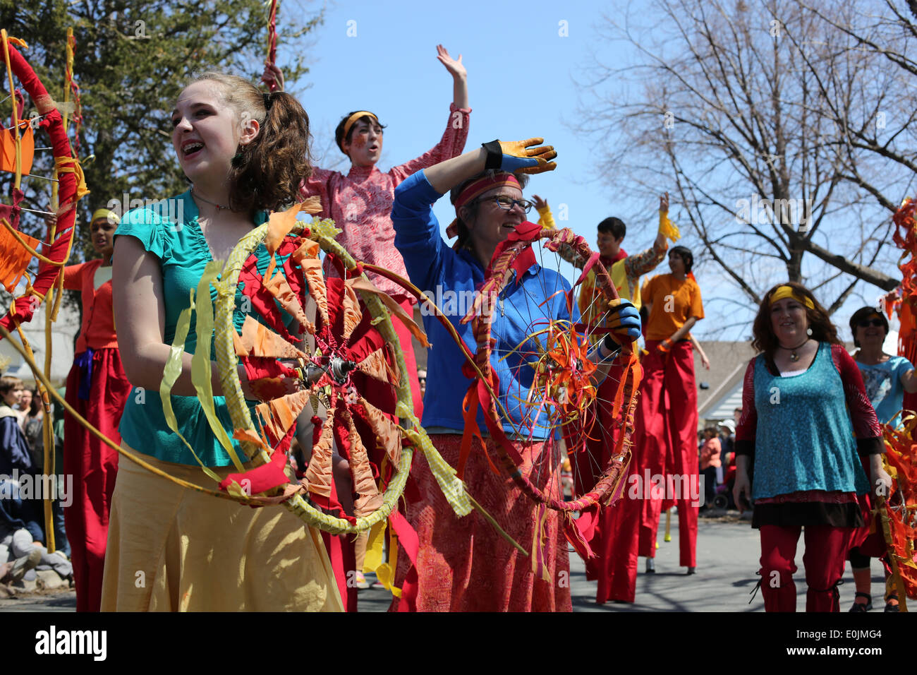 People dressed in colorful costumes marching in the May day parade in ...