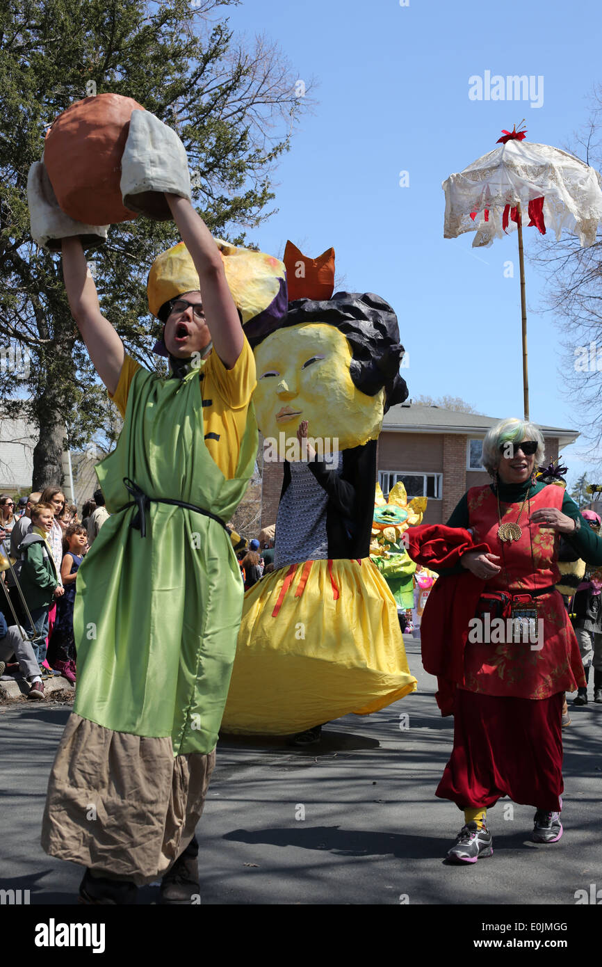 People dressed in colorful costumes marching in the May day parade in ...