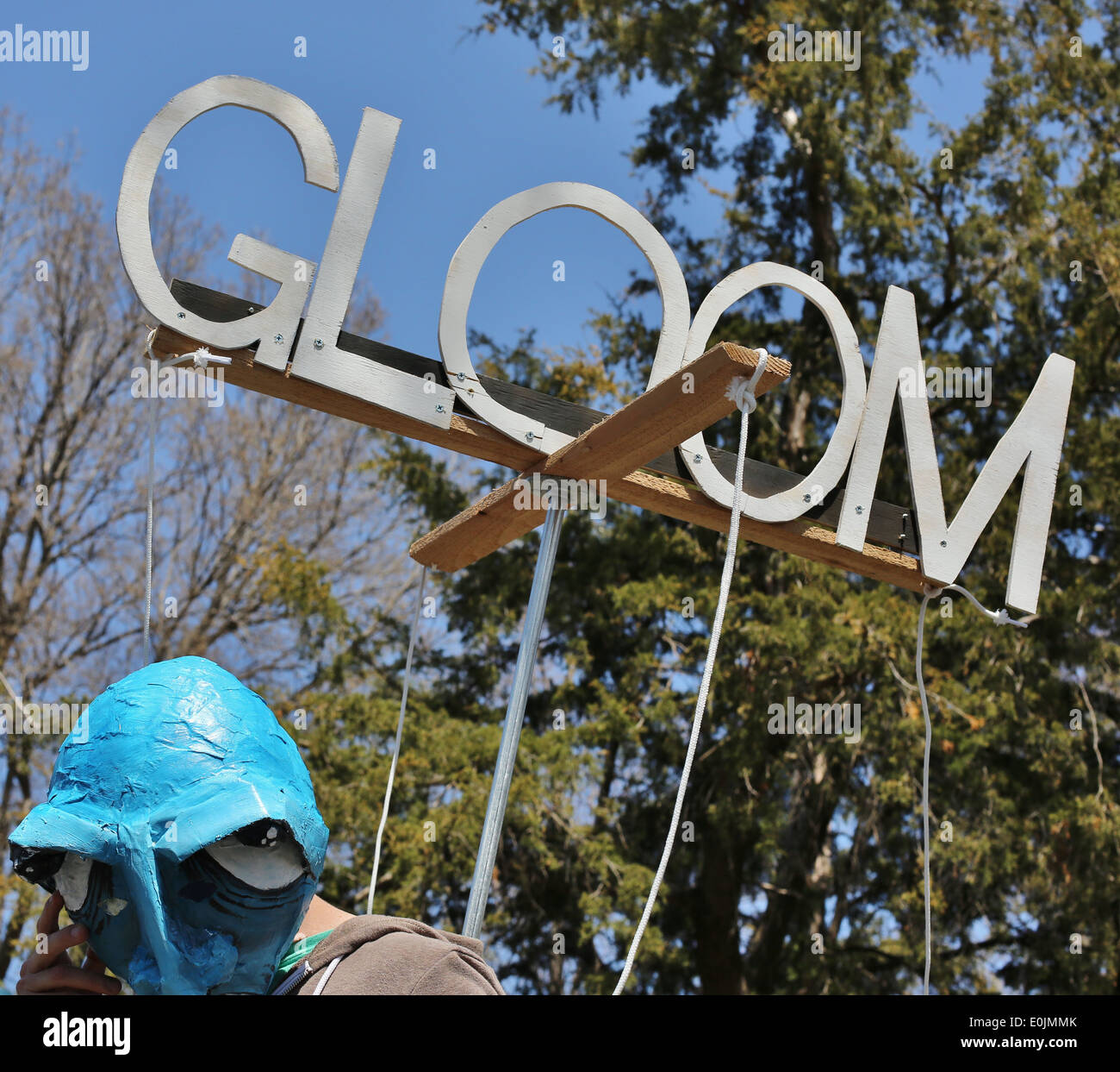 A person dressed as a sad creature holding the word "gloom Stock Photo ...