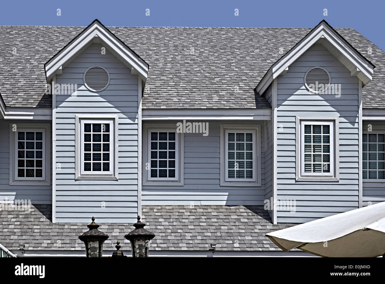 Dormer window and shingled roof construction with wood clad facade ...