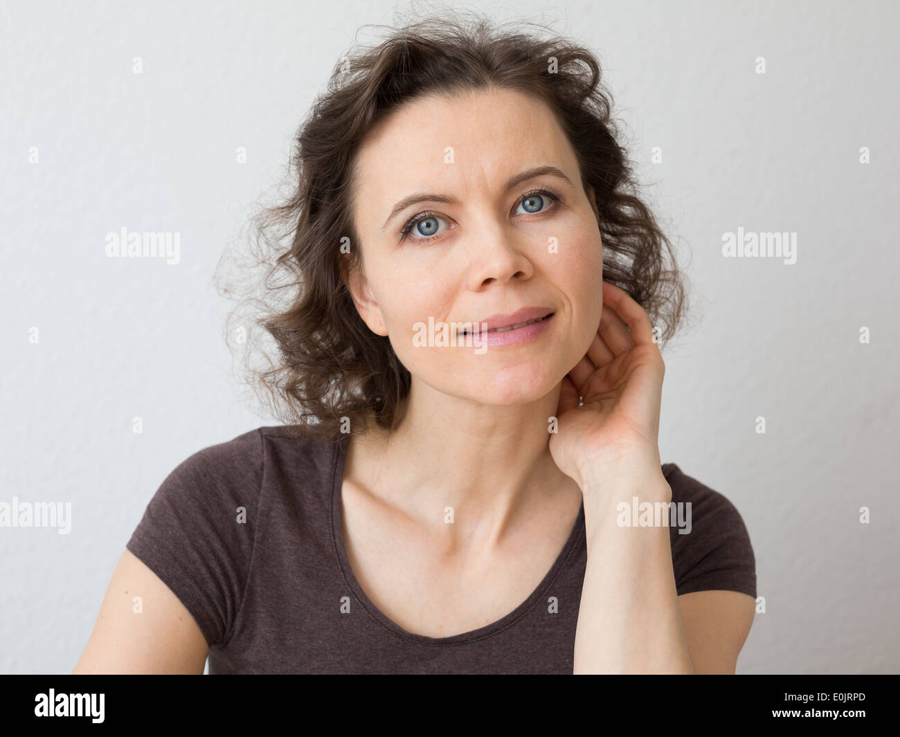 Happy woman looking into camera Stock Photo - Alamy