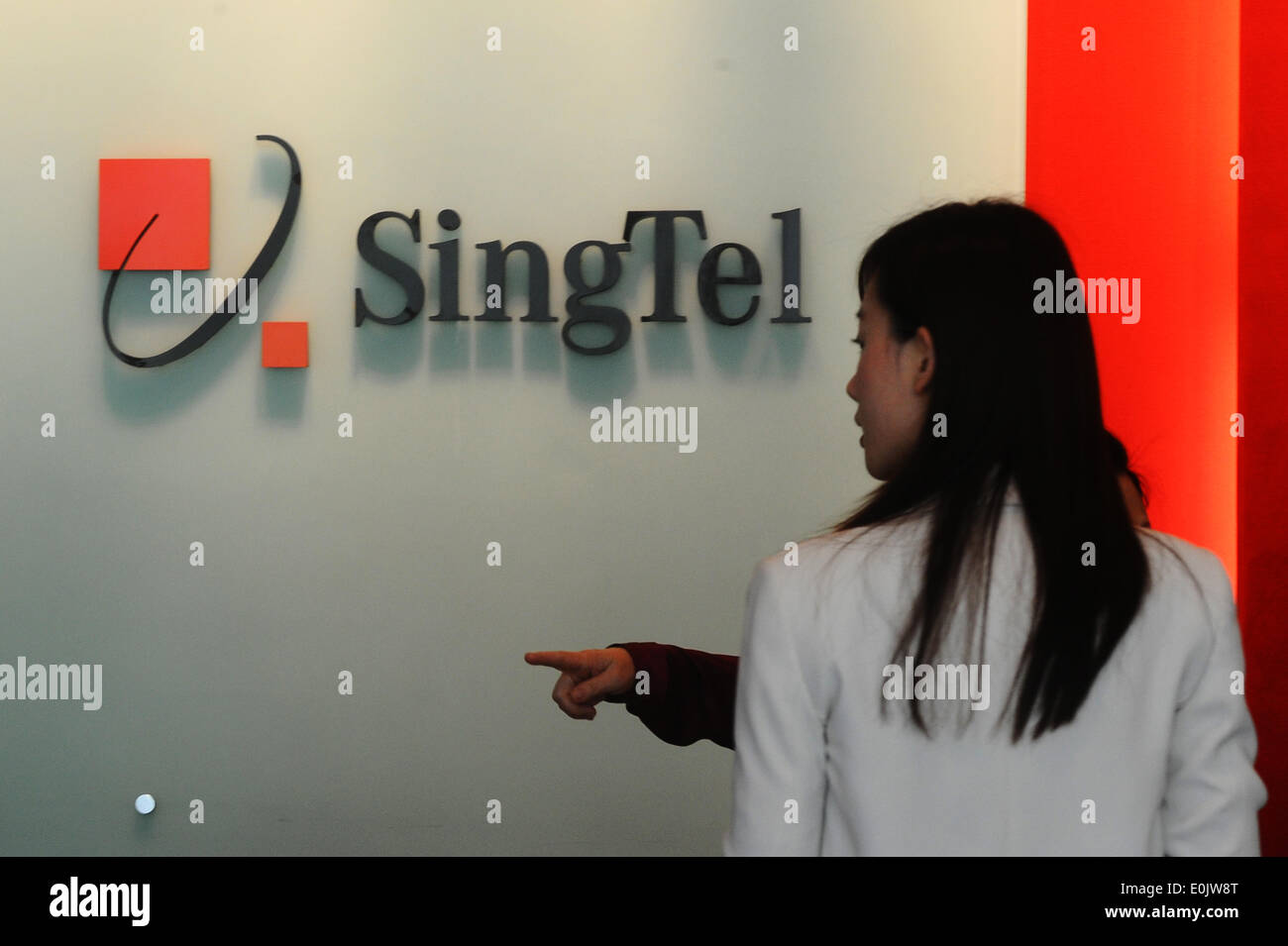 Singapore. 31st Mar, 2014. A receptionist talks to a customer at the ...