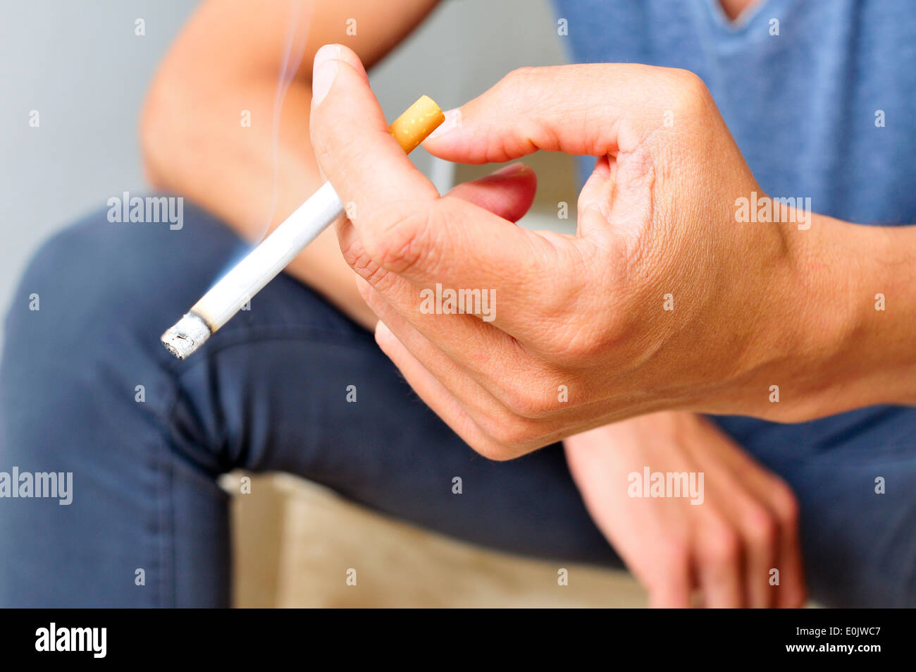 a young man smoking a cigarette Stock Photo - Alamy