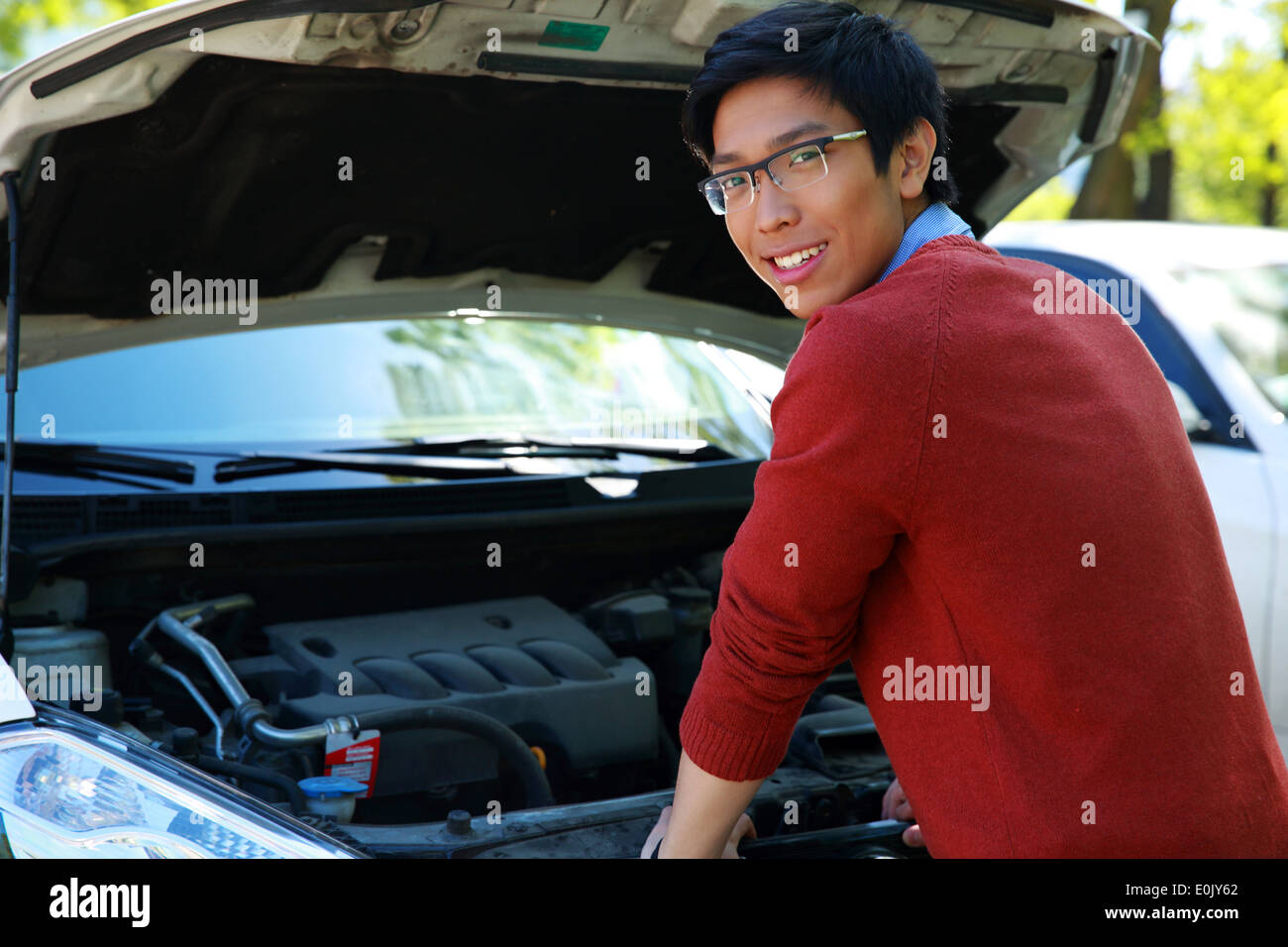 Young happy asian man checking his car engine Stock Photo - Alamy