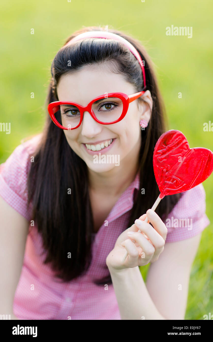 woman with heart lolly, (Model release Stock Photo - Alamy