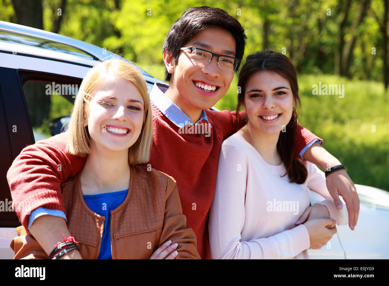 Happy friends standing outdoors Stock Photo - Alamy
