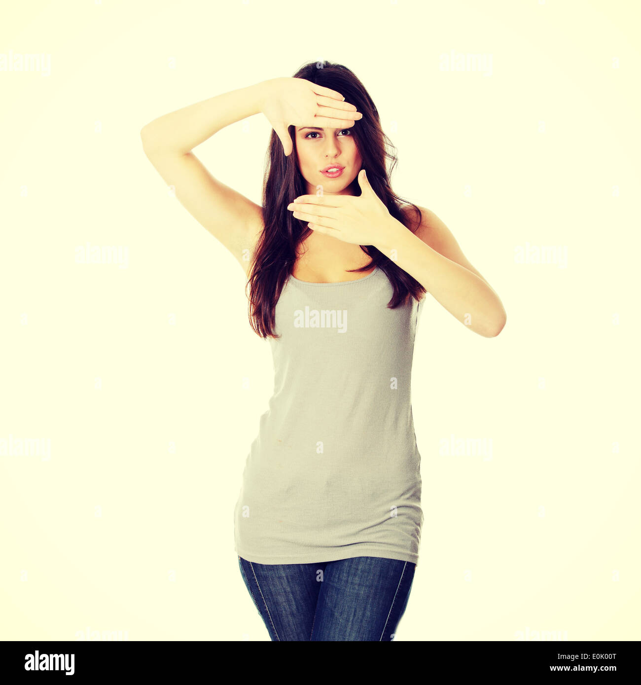 Woman framing her face with hands Stock Photo - Alamy