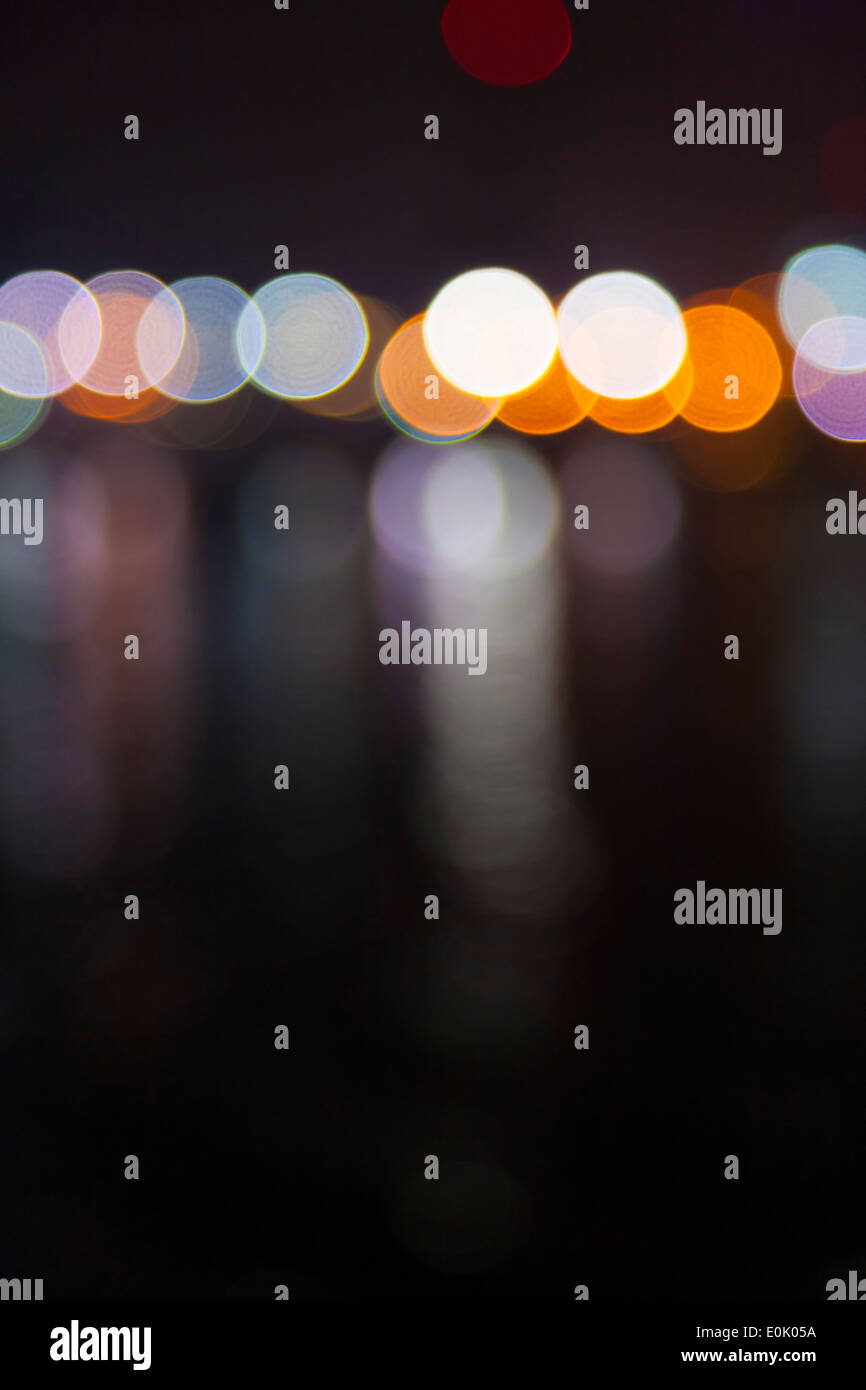 Coloured lights reflecting in water at night Stock Photo - Alamy