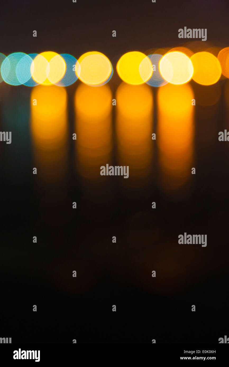 Coloured lights reflecting in water at night Stock Photo - Alamy