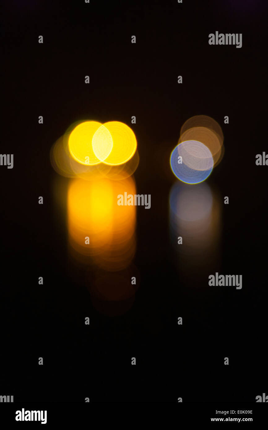 Coloured lights reflecting in water at night Stock Photo - Alamy