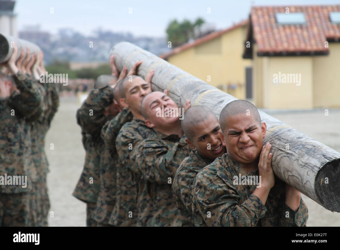 U.S. Marine Corps recruits work together to lift the front end of a ...