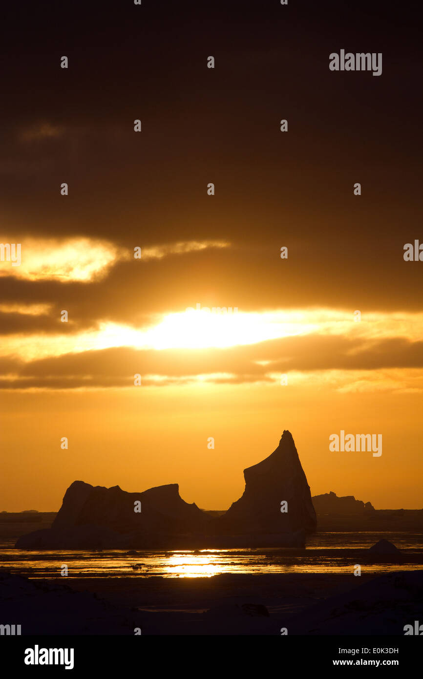 Antarctic iceberg against the Antarctic summer sunset background Stock ...