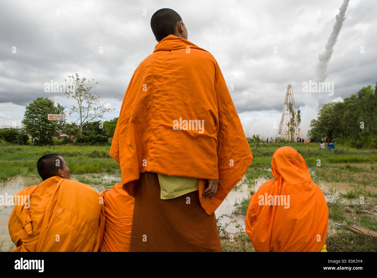 Yasothon, Thailand. 13th May, 2007. Buddhist monks look up as a rocket ...