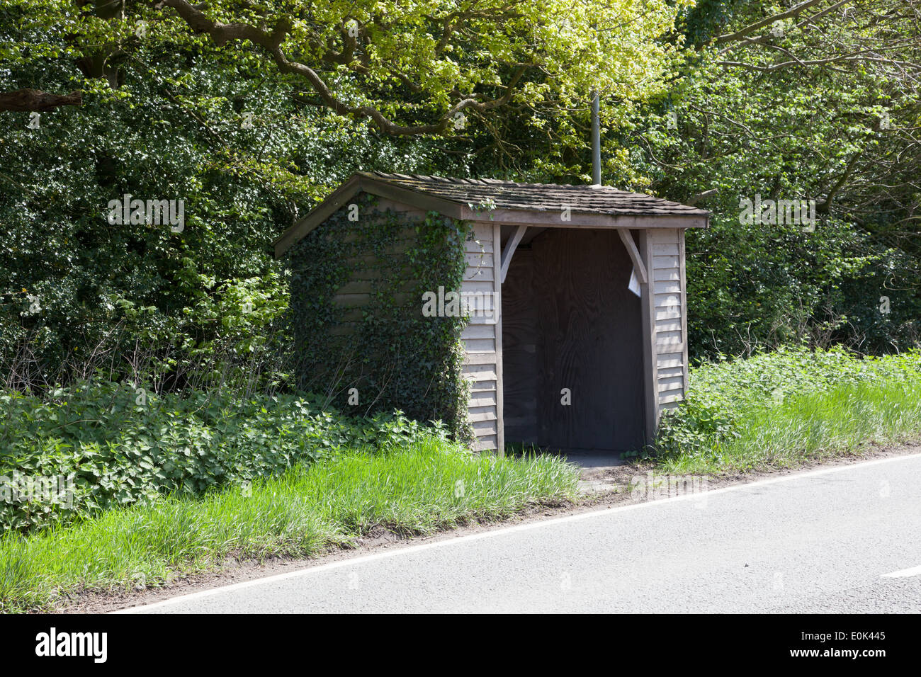 A rural wooden Bus Stop with ivy growing over it Stock Photo - Alamy