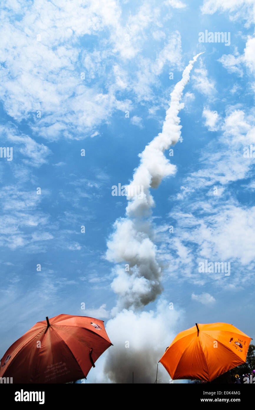 Yasothon, Thailand. 11th May, 2014. A rocket is launched into the air ...