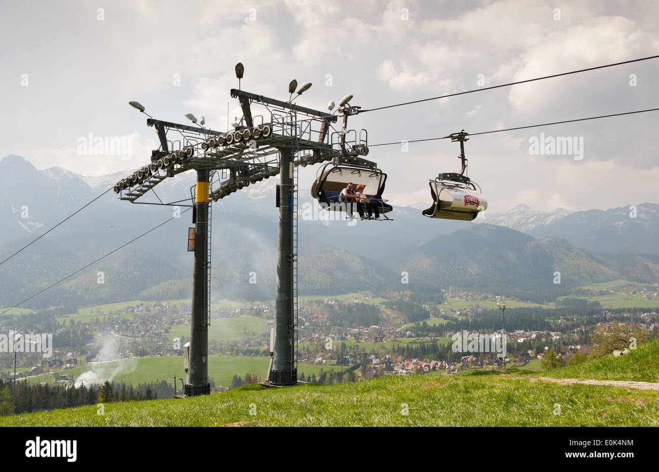 Ropeway chairlift tourist fun attraction high view, passengers in chair ...