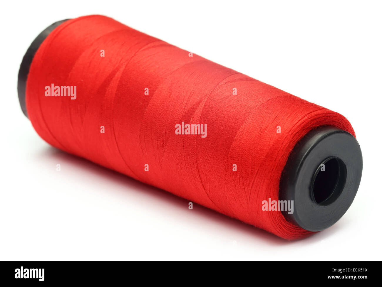 Large thread reel over white background Stock Photo - Alamy