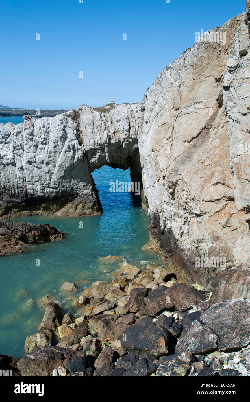 Bwa Gwyn white natural rock sea arch on coast, near Rhoscolyn, Anglesey ...