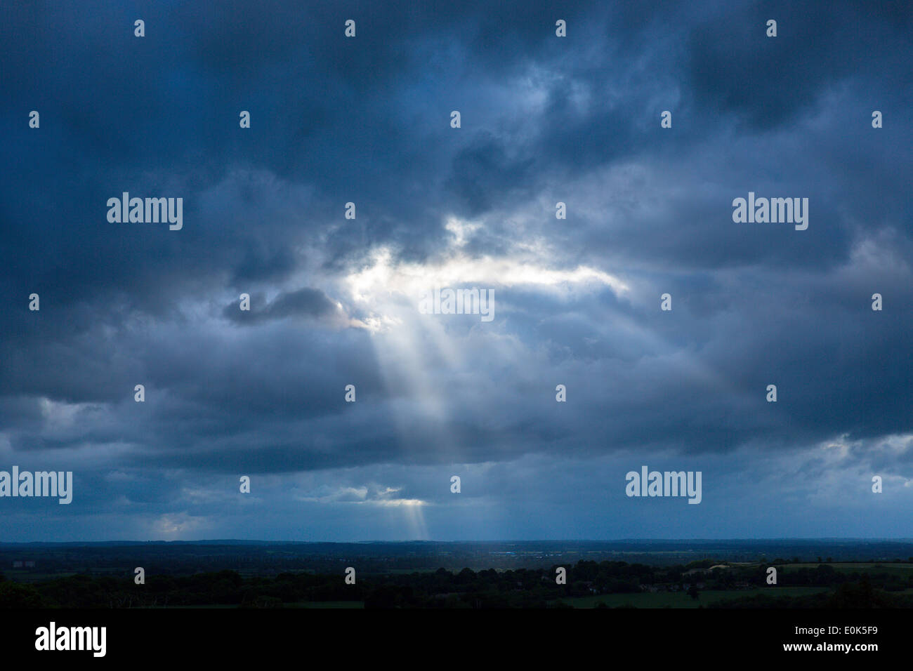 Sun rays through storm clouds hi-res stock photography and images - Alamy