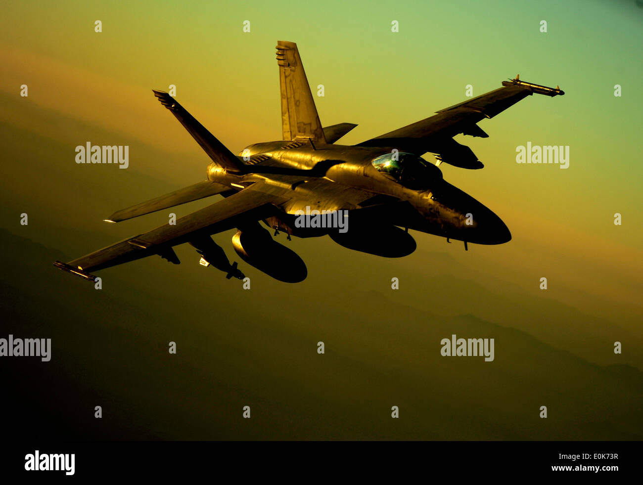 A U.S. Navy F/A-18 Hornet maneuvers into position for aerial refueling ...
