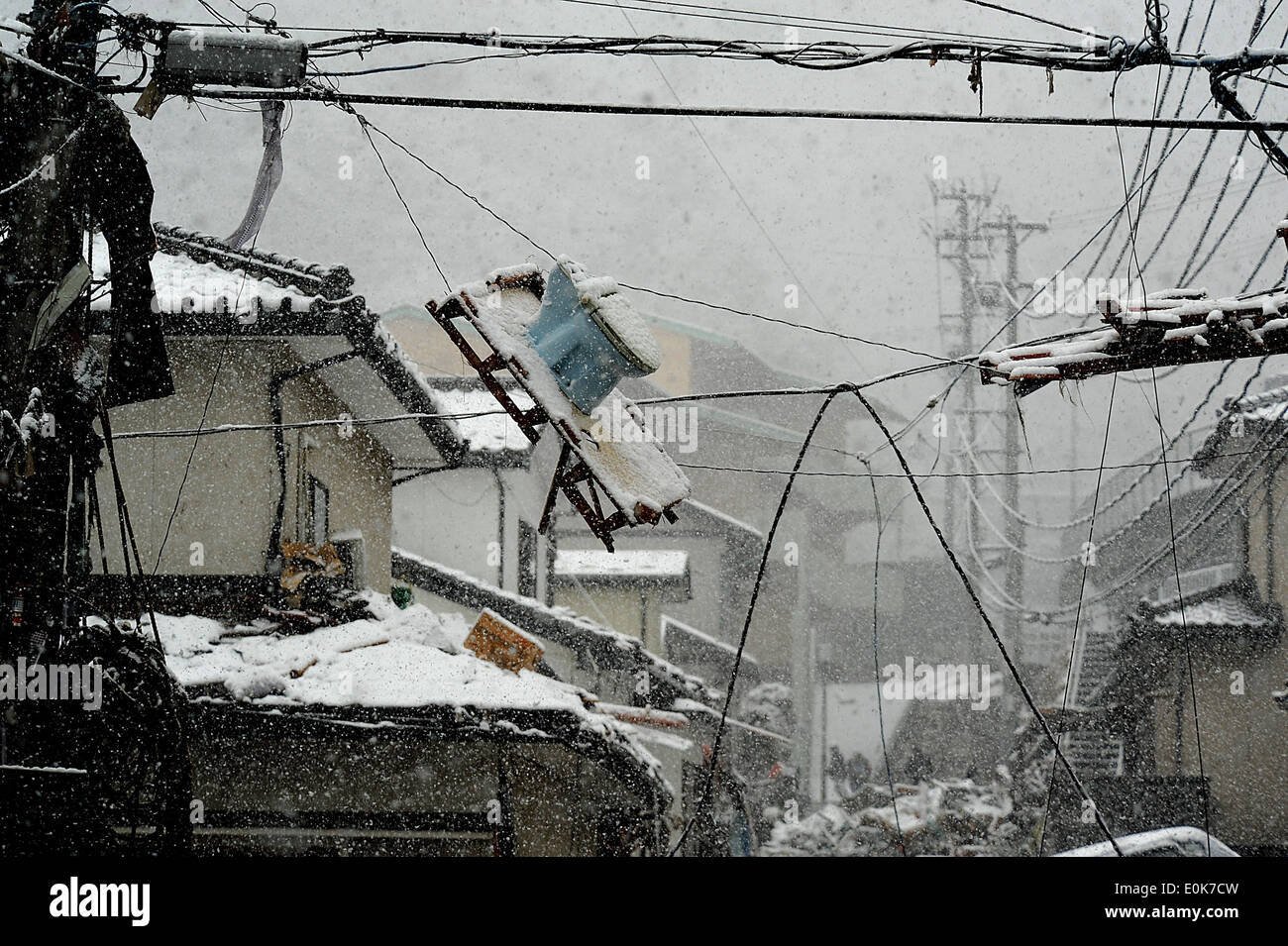 A toilet rests on top of some power lines on March 16, 2011 in Ofunato ...