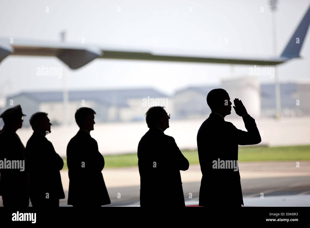 President Barack Obama, in the process of saluting, participates in a ...