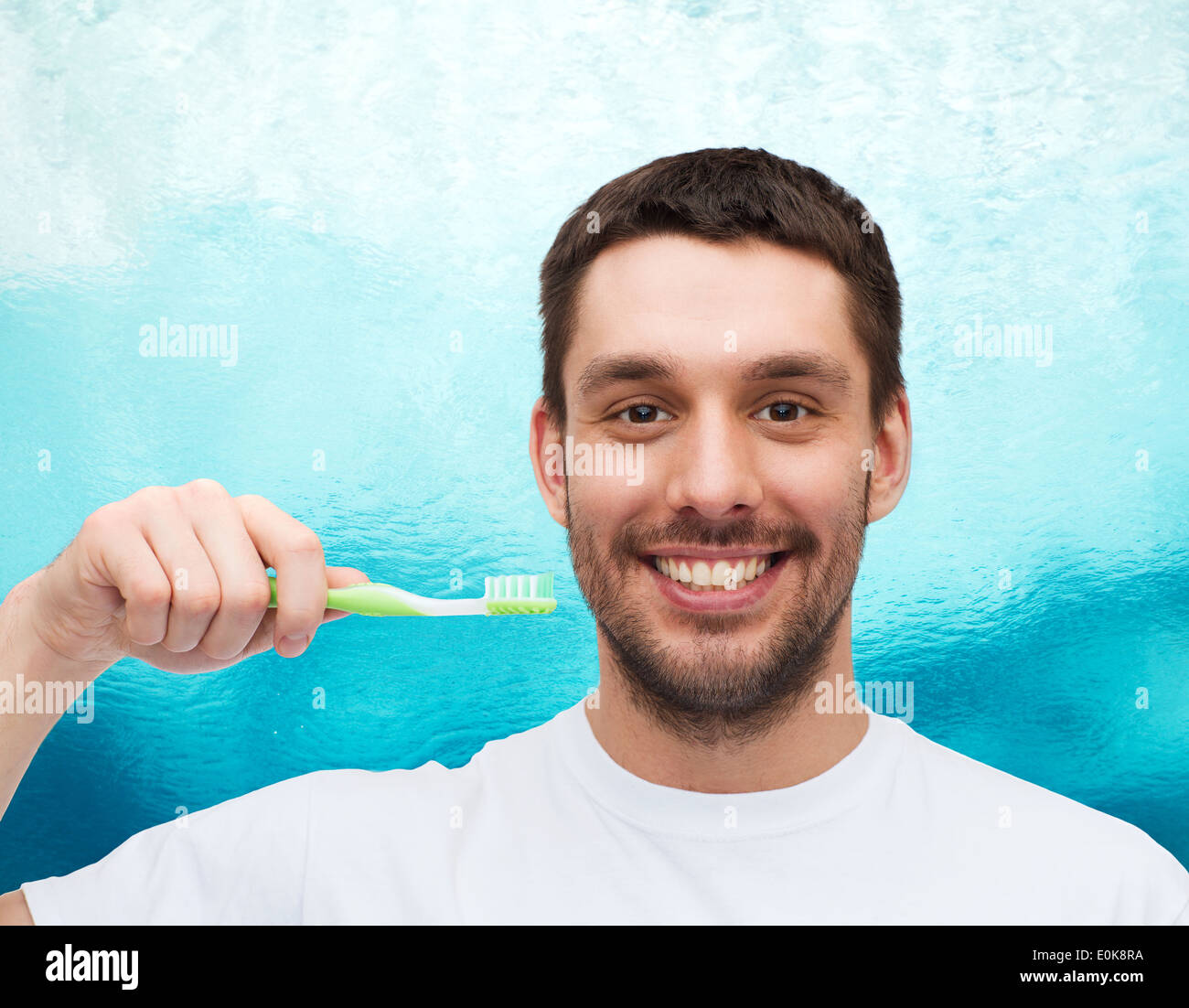 smiling young man with toothbrush Stock Photo - Alamy
