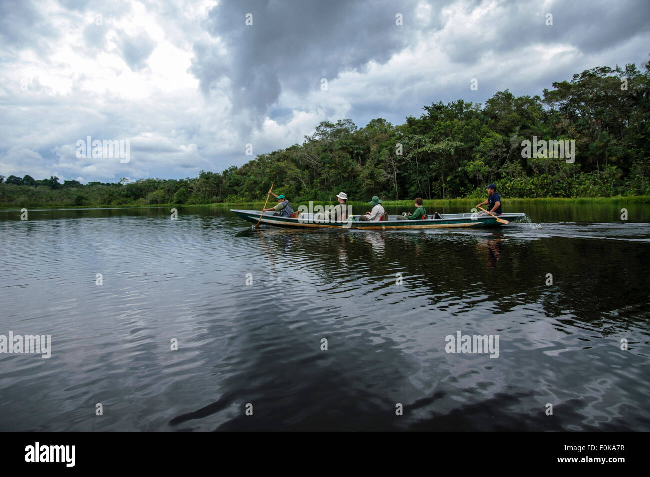 Group of tourists navigating in a canoe on the Amazon River Stock Photo ...