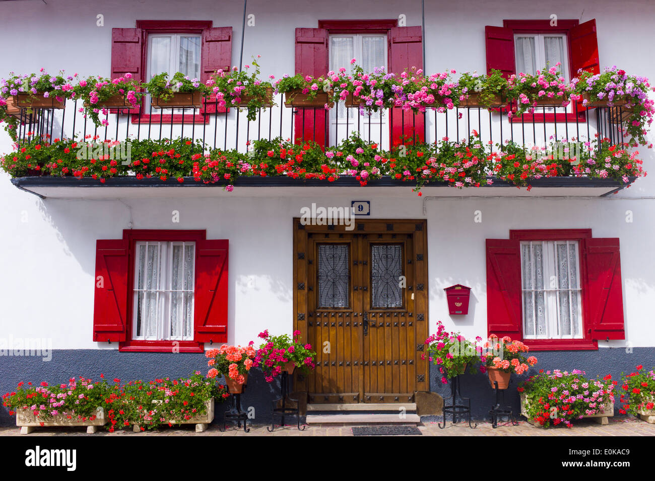 Typical Basque townhouse with geraniums in flower box in town of Oroz ...