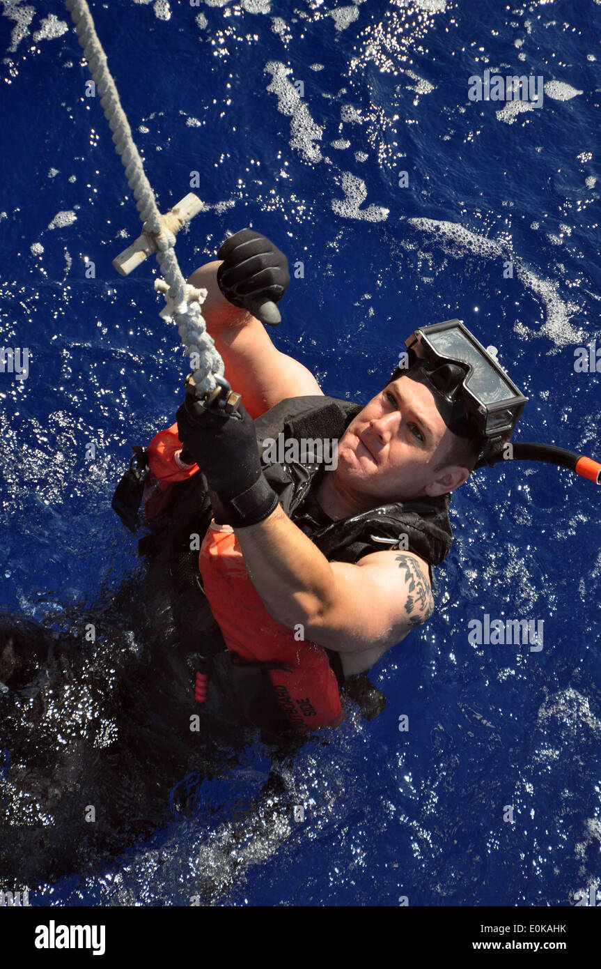 Petty Officer 2nd Class Collin Reed gives a thumbs-up to signal a ...
