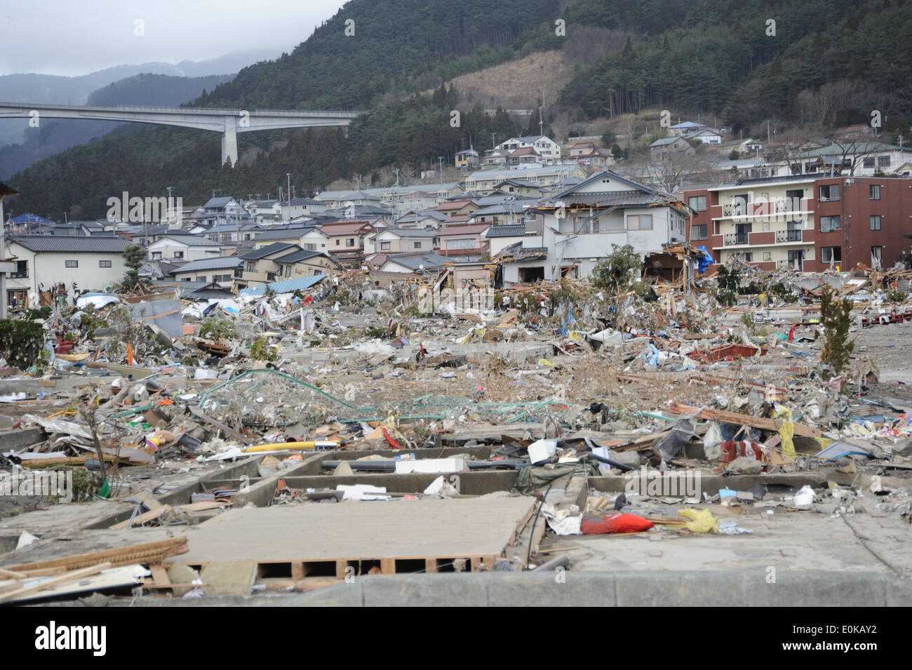 Houses and apartment buildings overlook the tsunami aftermath after an ...