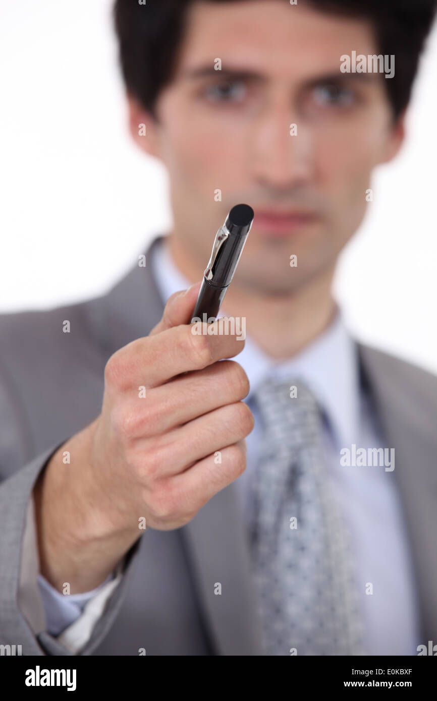 Holding out pen for signature Stock Photo - Alamy