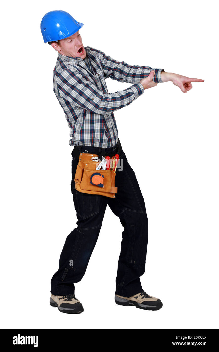 Construction worker pointing in shock Stock Photo - Alamy