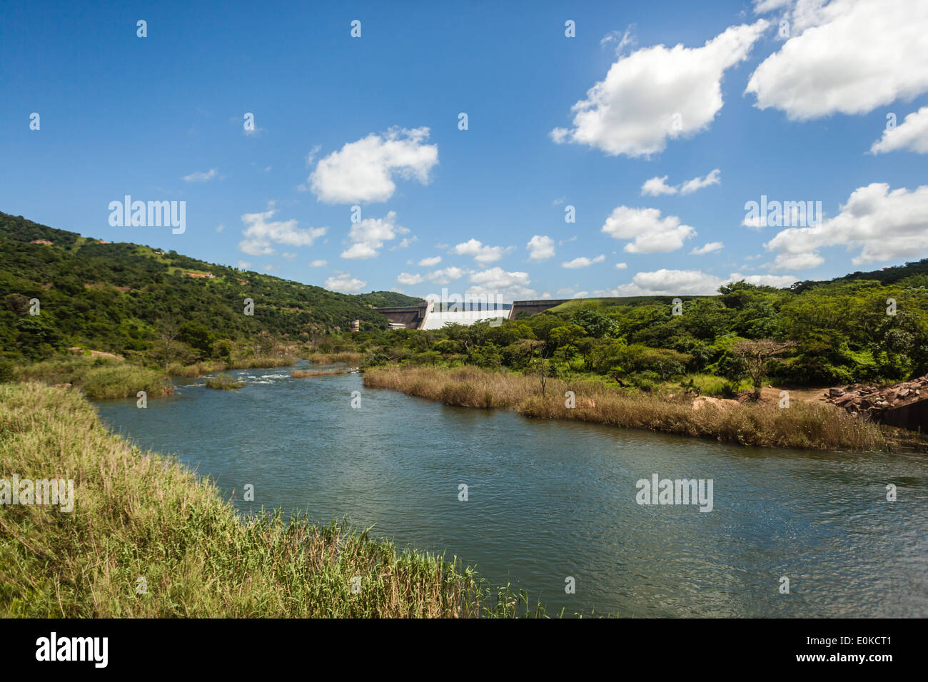 Dam Wall structure with rain water flowing over top into river valley ...