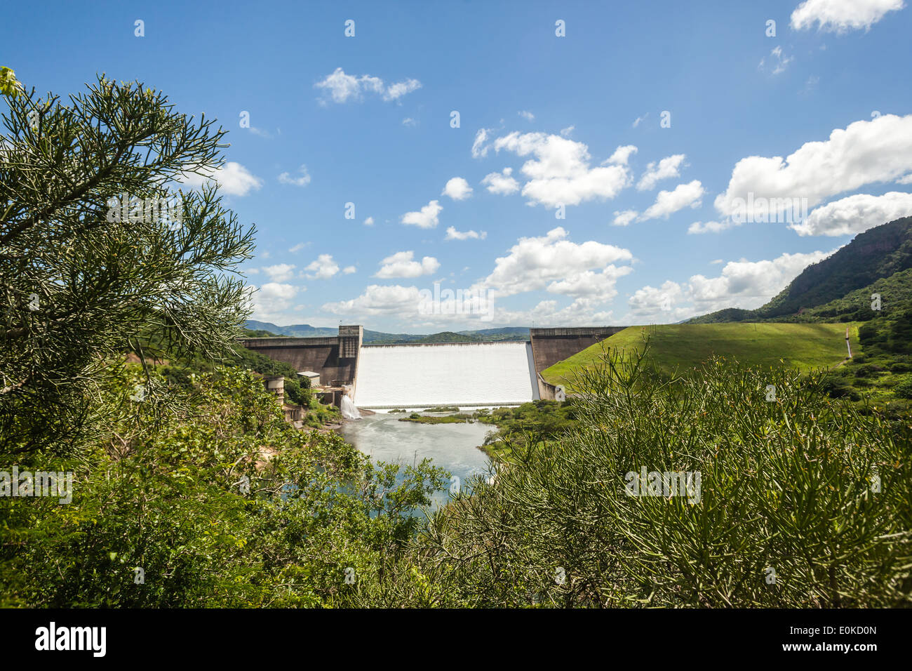 Dam Wall structure with rain water flowing over top into river valley ...