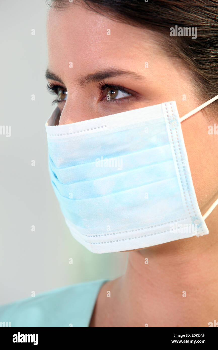 Brunette nurse wearing mask Stock Photo - Alamy