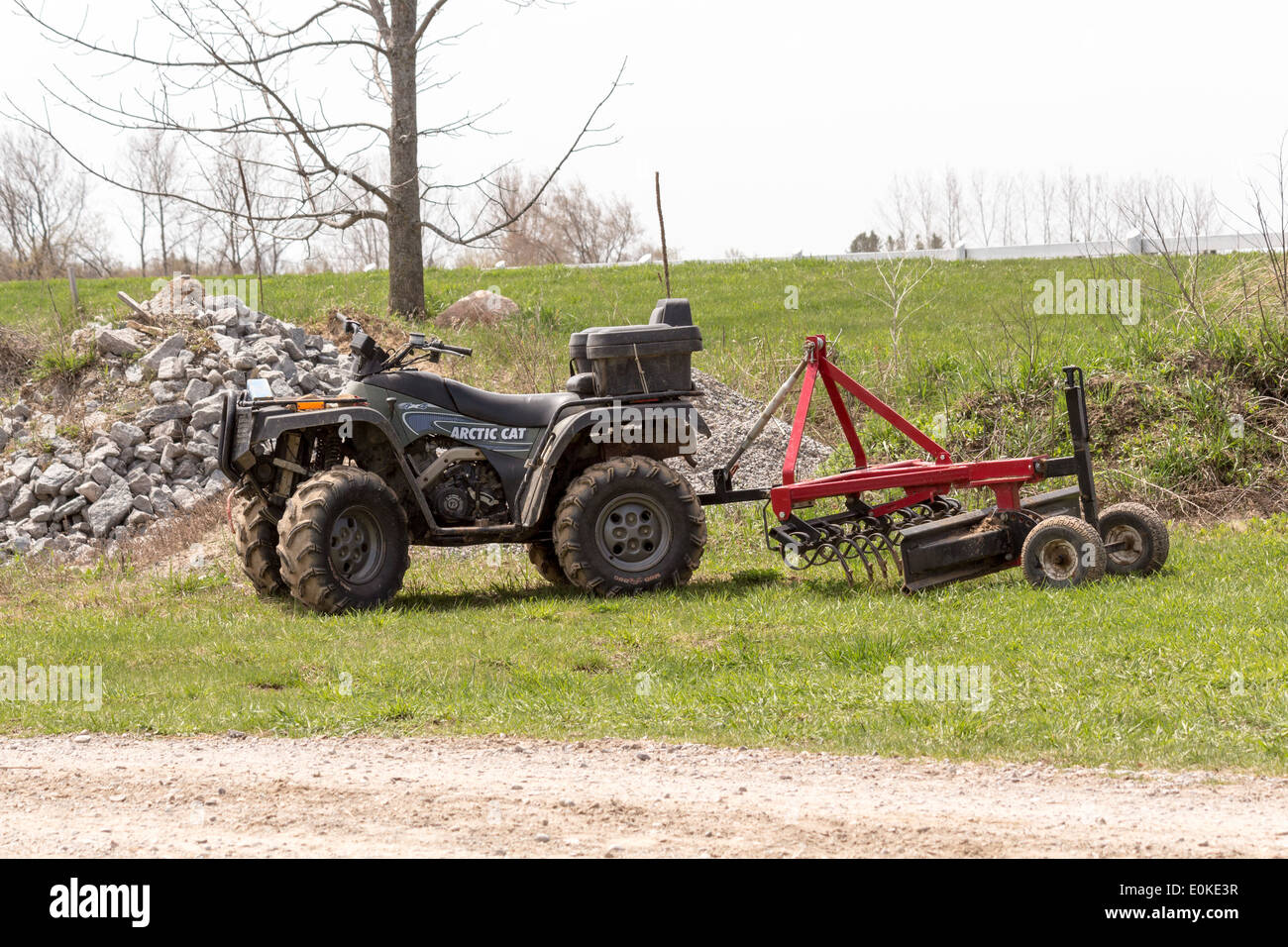 Arctic Cat four wheeler with attached rake and blade Stock Photo - Alamy