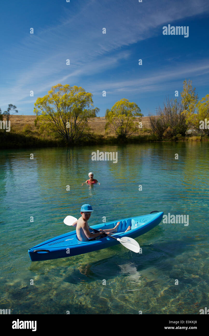 Kayak and swimmer, Ohau River in autumn, near Twizel, Mackenzie Country ...