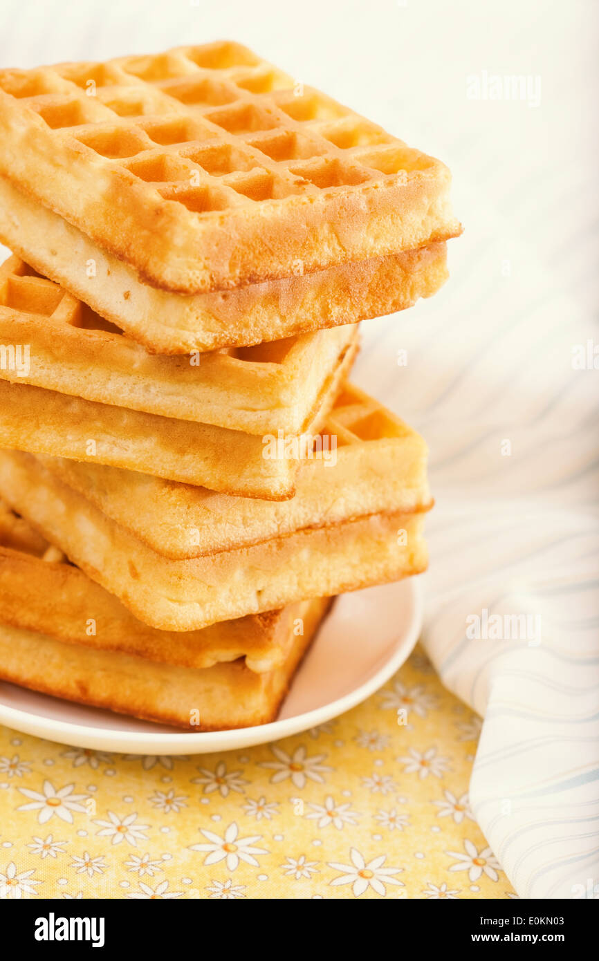 Sweet Belgian waffles on a plate on table Stock Photo - Alamy