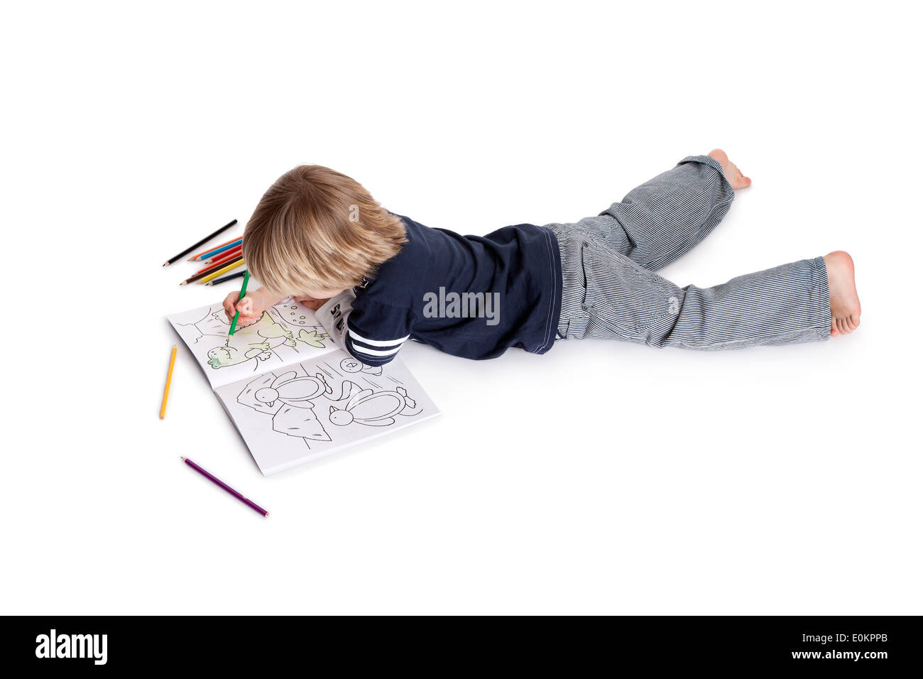 Little Boy Lying On The Floor With A Colouring Book On White Background