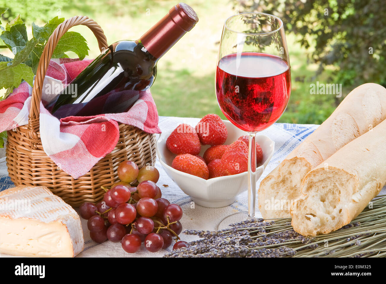 Romantic picnic setting with wine, bread and cheese Stock Photo - Alamy