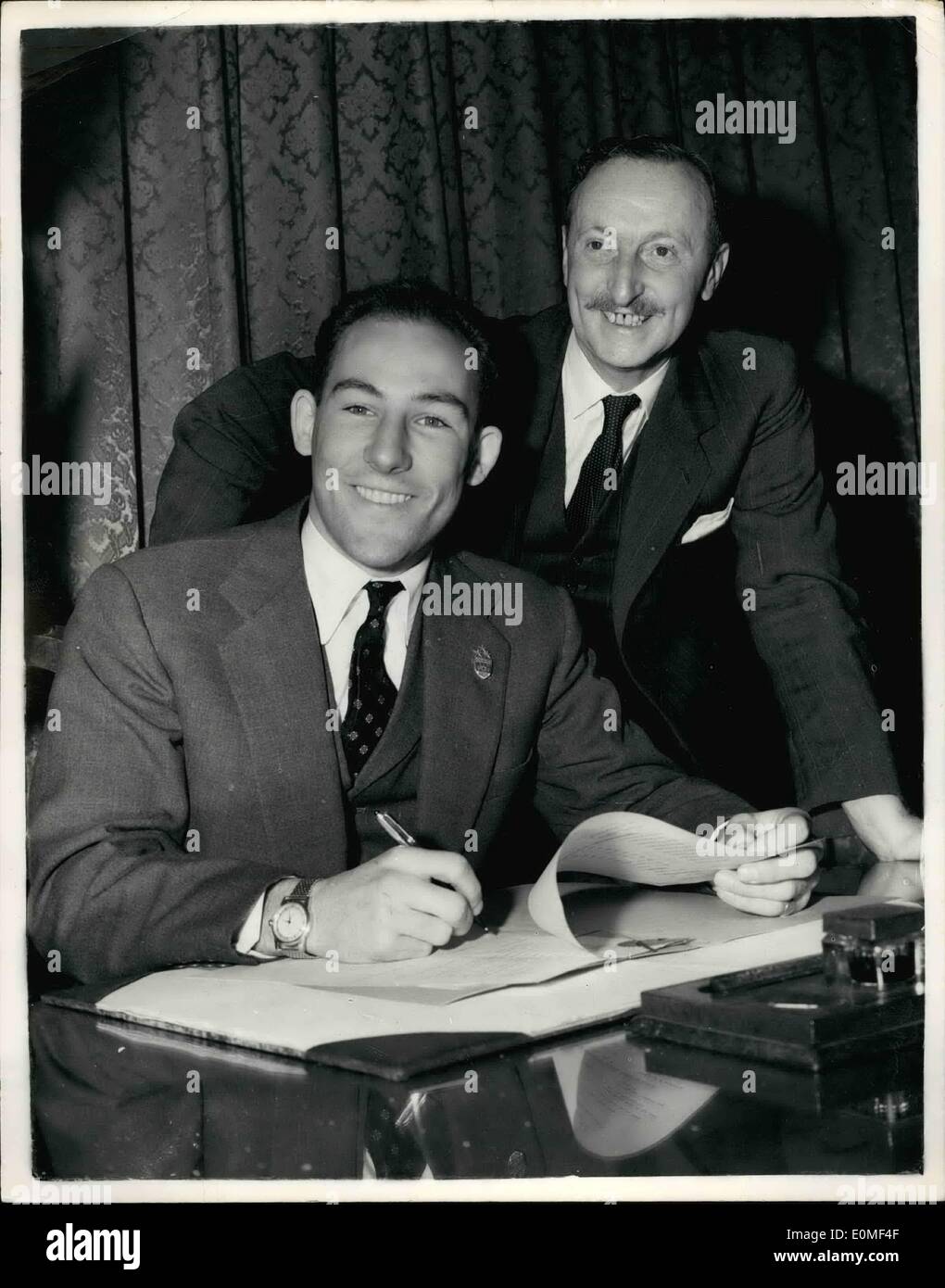 Dec. 12, 1954 - Stirling Moss signs Mercedes Contract. Photo shows ...
