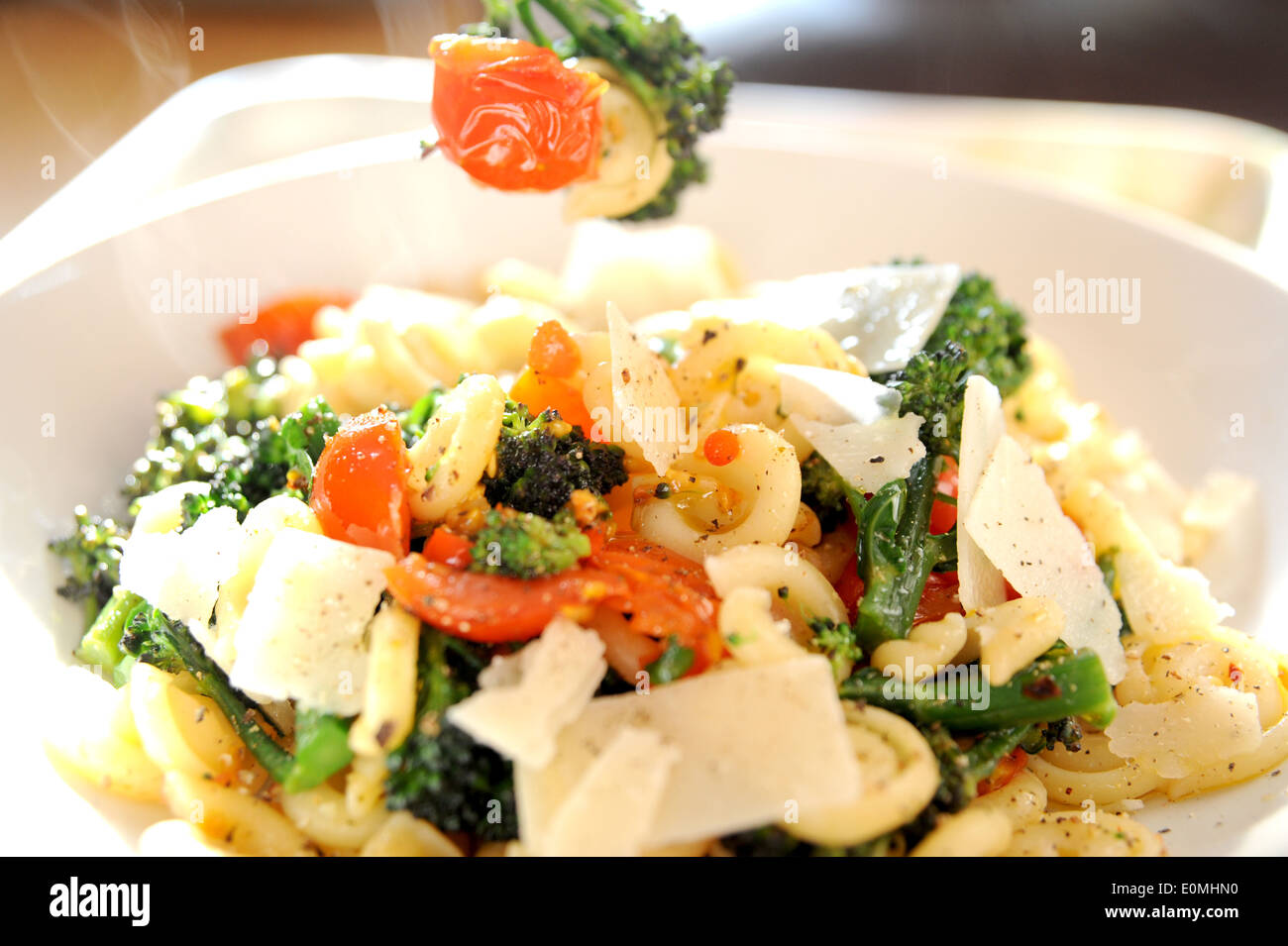 Bowl of Messicani pasta with cherry tomatoes , broccoli and parmesan ...