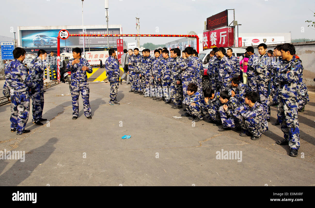 Chinese security guards line up in front of their commander in front of ...