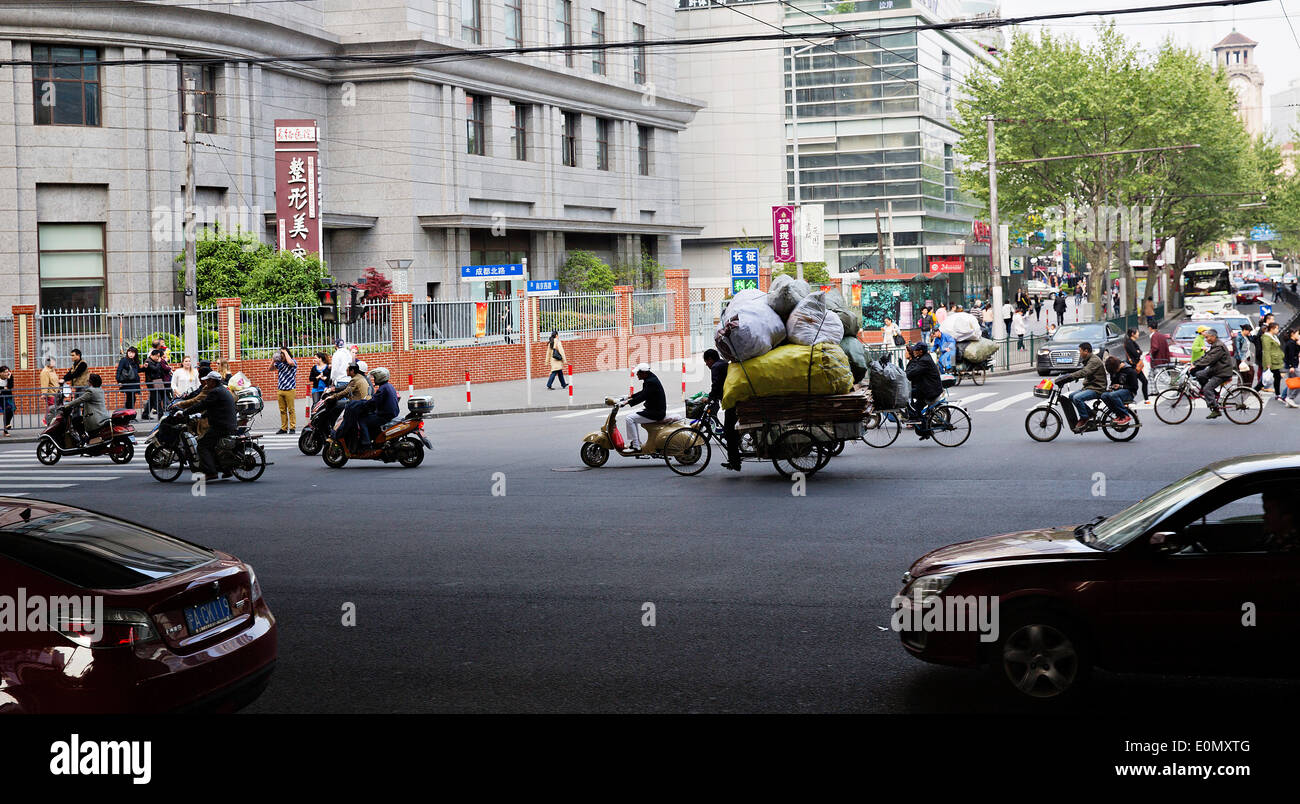 Dozens of motor bikes make their way through city traffic in Shanghai ...